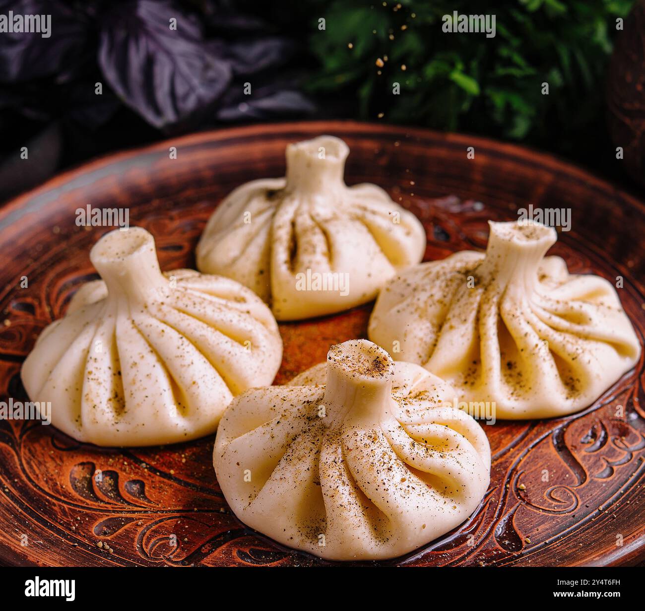 Traditional georgian dumplings, khinkali, served on a carved wooden ...
