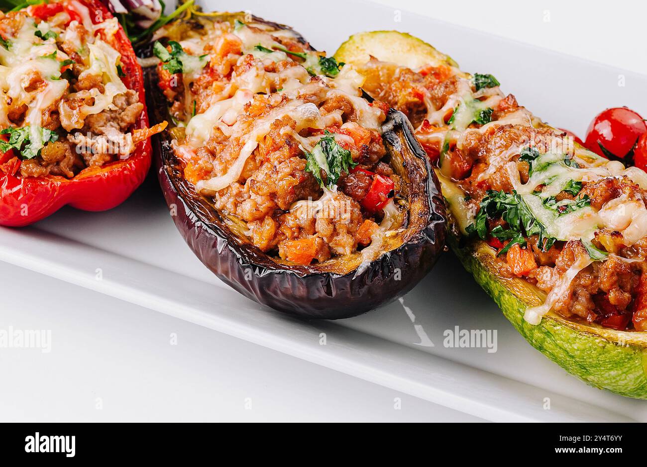 Colorful bell peppers filled with seasoned meat and melted cheese ...