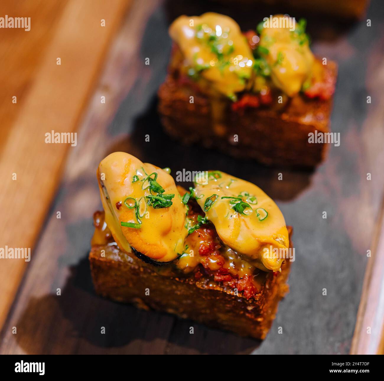 Elegant small bites served on a rustic wooden plank, perfect for fine ...