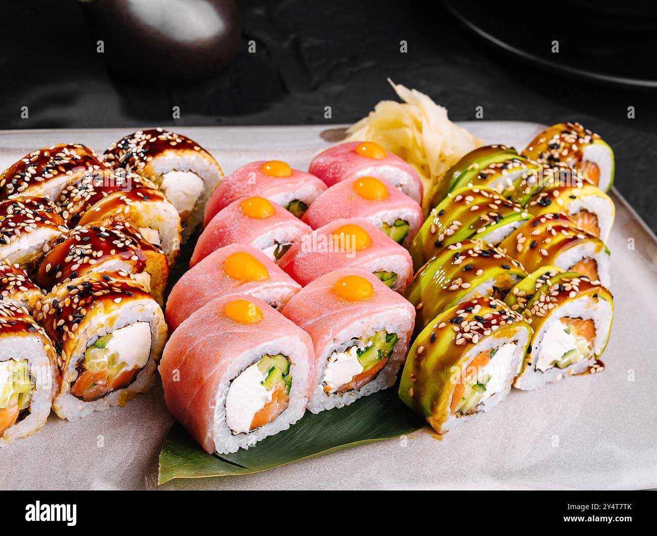 Selection of sushi rolls with diverse toppings served on a stylish ...