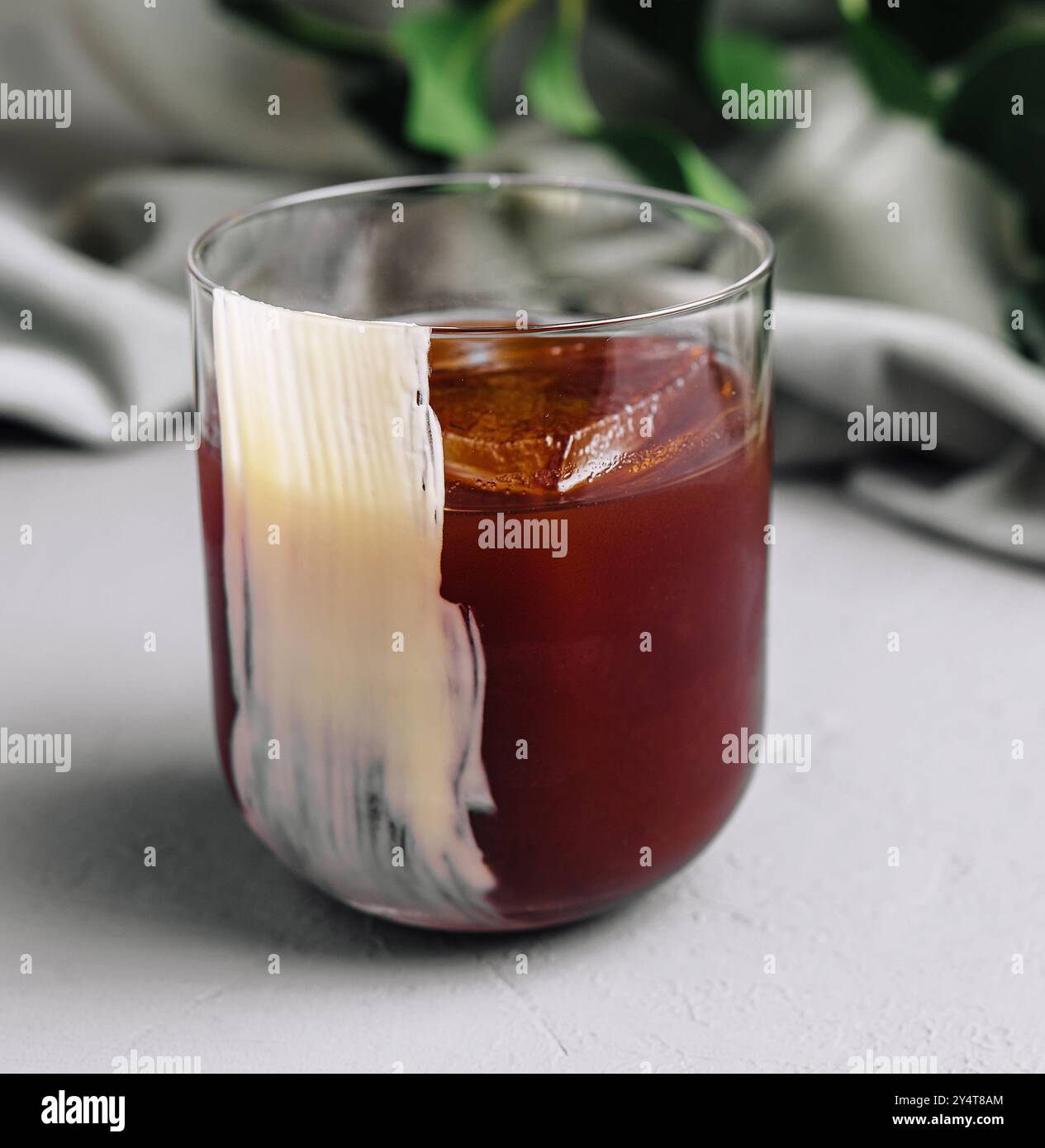 Glass of cold brew coffee with ice, elegantly placed on a sleek ...