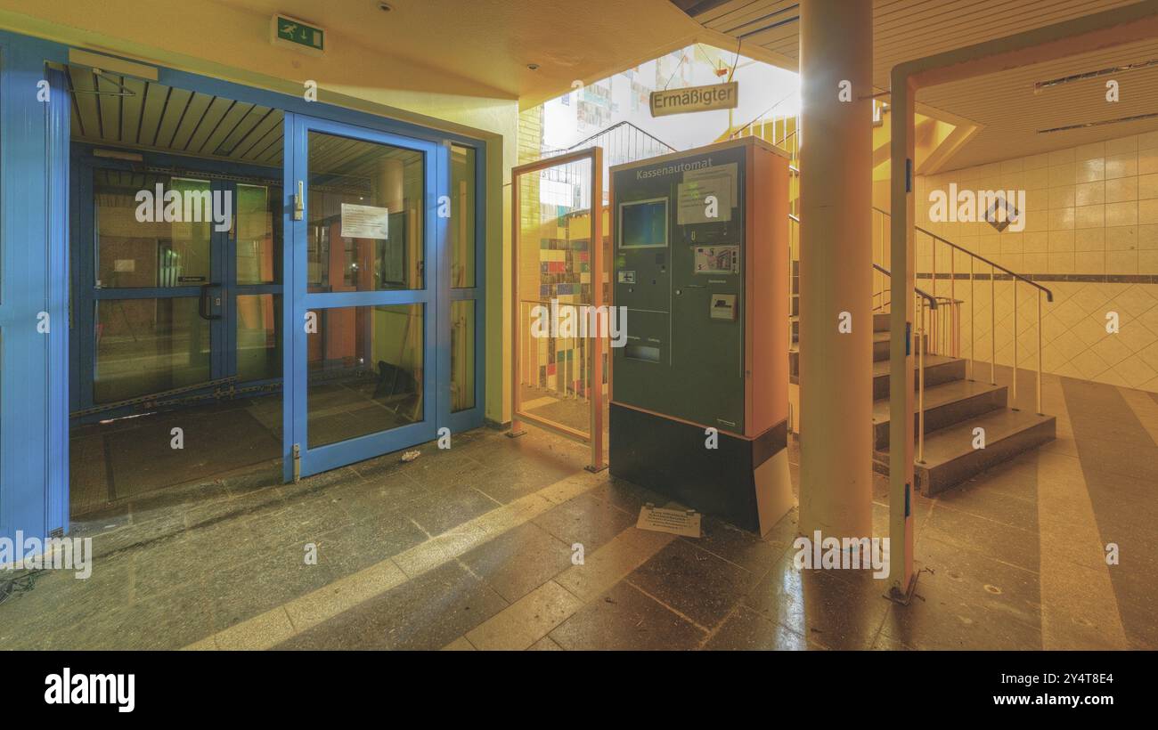 A reception area with vending machines, stairs and an entrance door ...
