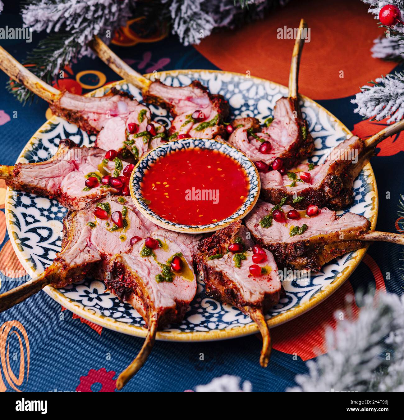 Gourmet serving of roasted lamb ribs with tangy pomegranate sauce ...