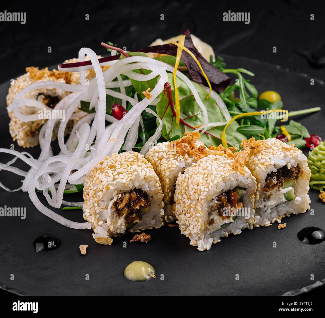 Gourmet sushi rolls with sesame seeds served with wasabi, ginger and ...