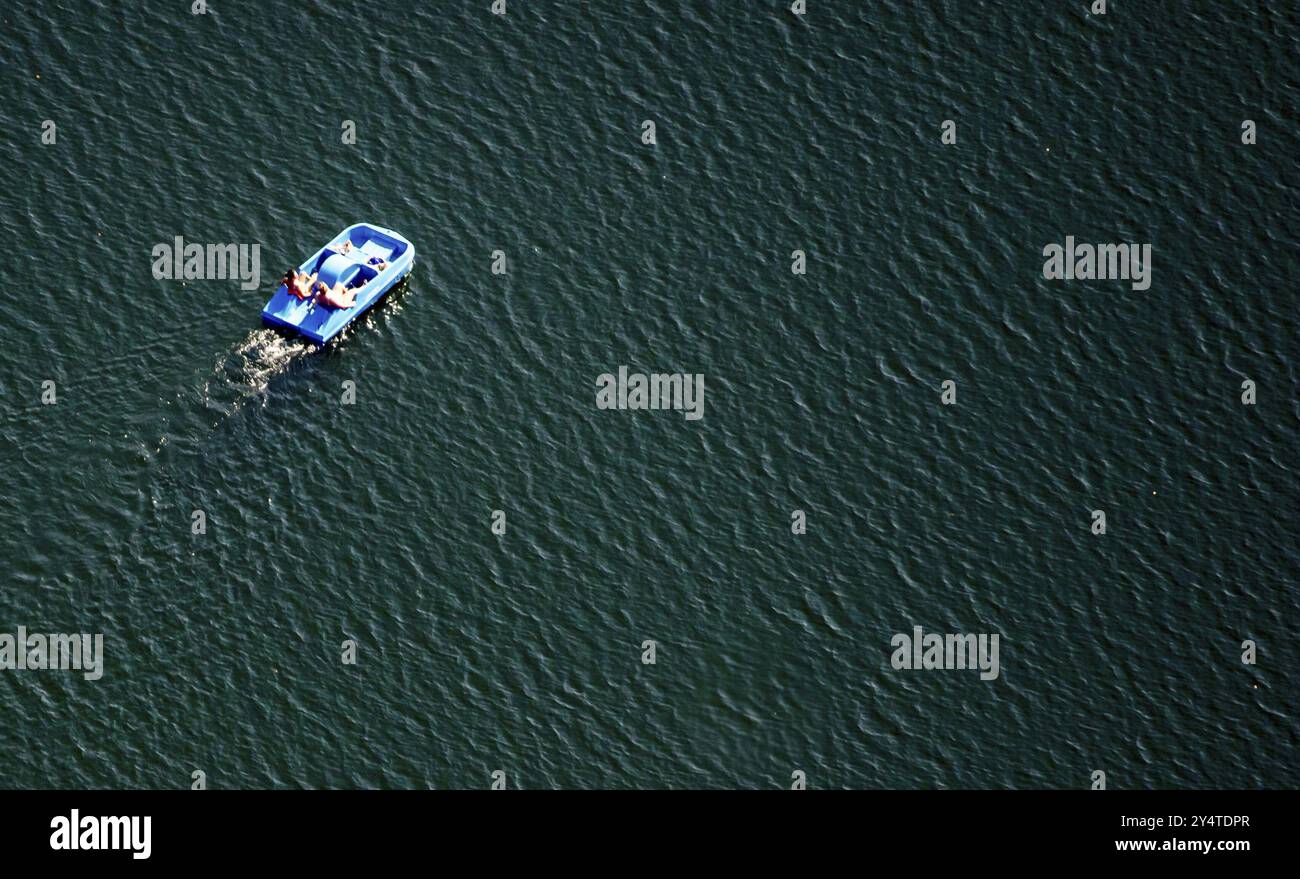 Two people sinking in a pedalo on a lake Stock Photo - Alamy