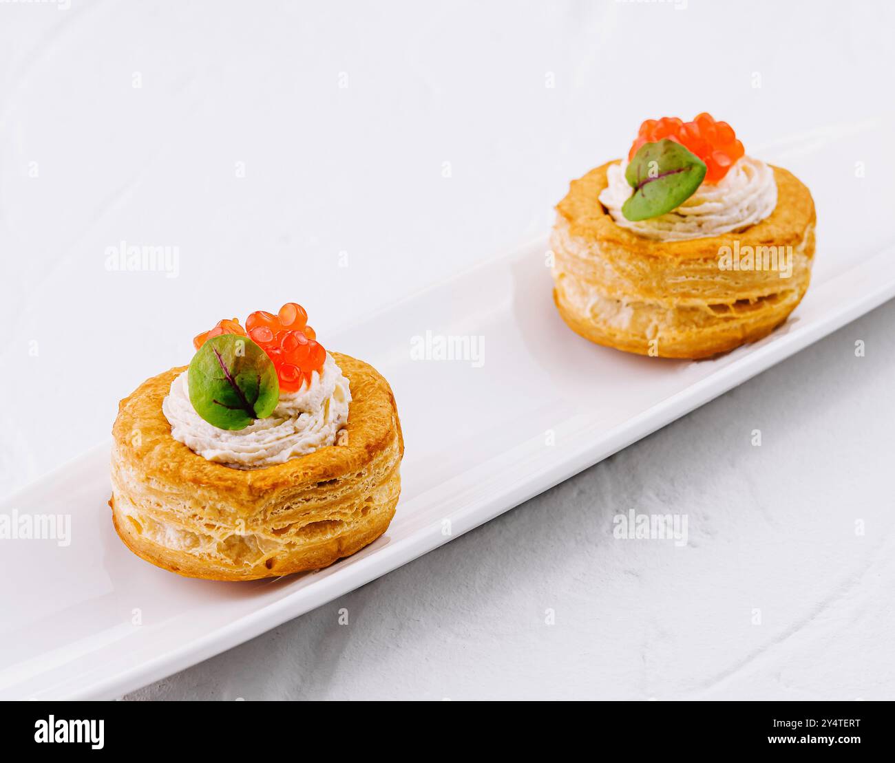 Elegant puff pastry vol-au-vent filled with cream and topped with ...