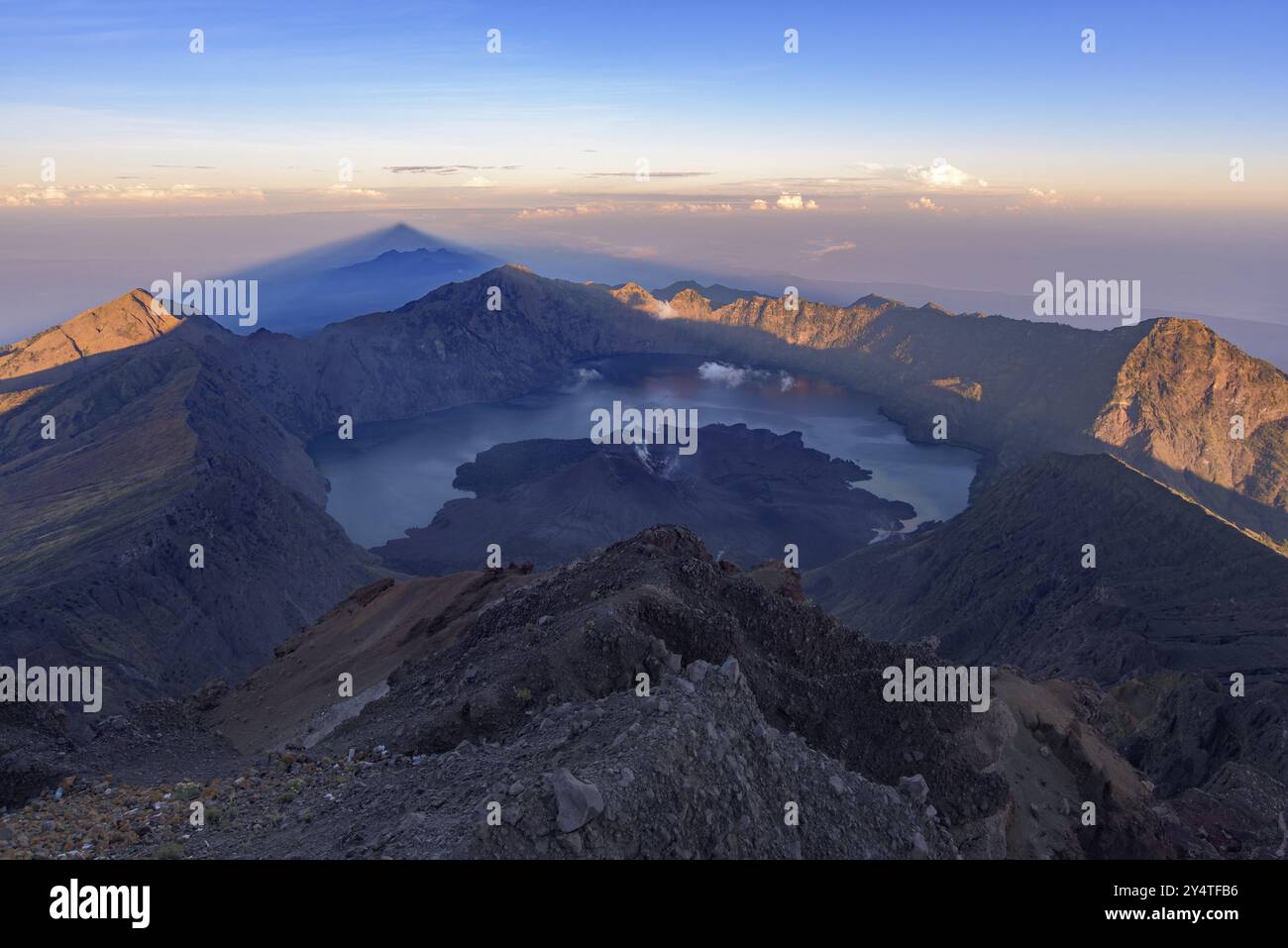 The shadow of peak caused by sunrise, Crater Lake of Rinjani Volcano ...