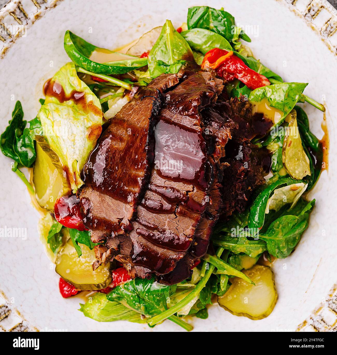 Savory beef steak served atop a fresh mixed greens salad, culinary ...
