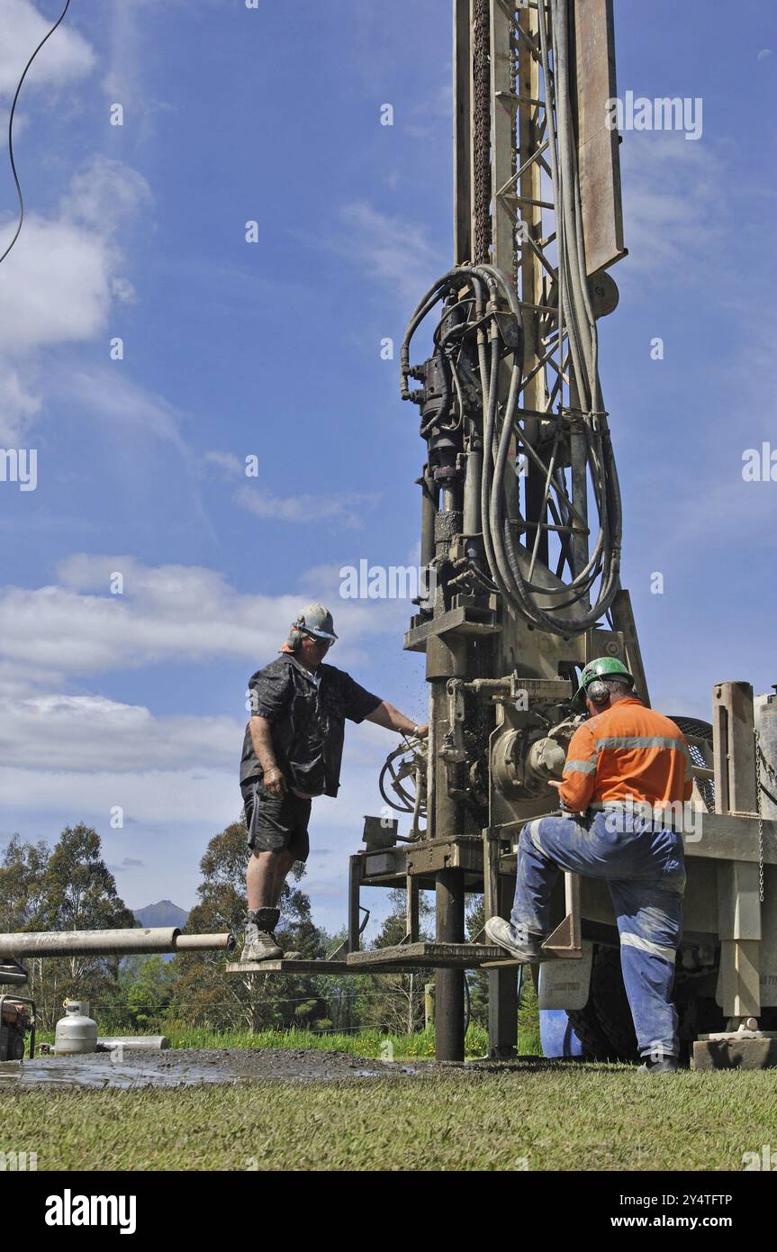 A drilling rig operator aims for an underground water supply near ...