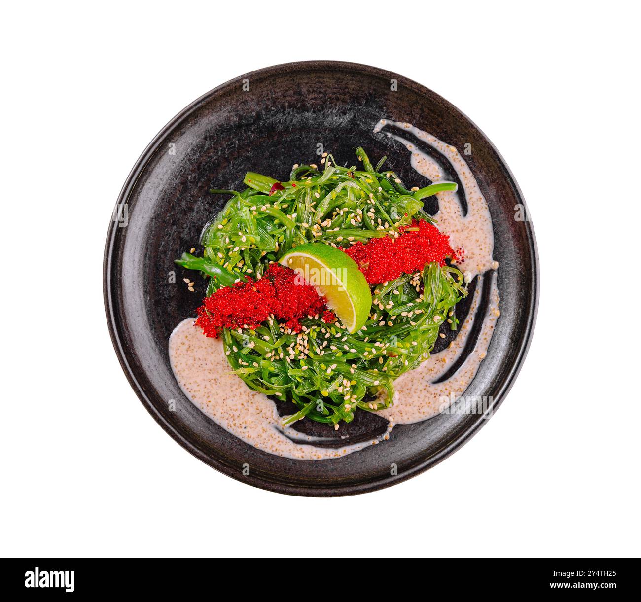 Elegant seaweed salad topped with bright red tobiko and lime hi-res ...