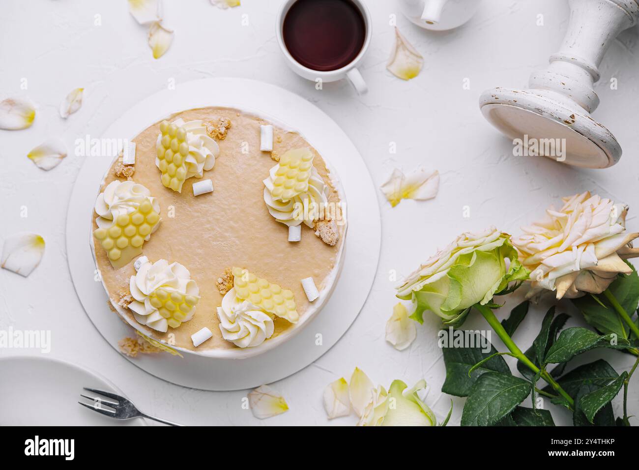 Top-down view of a beautifully decorated vanilla cake alongside fresh ...