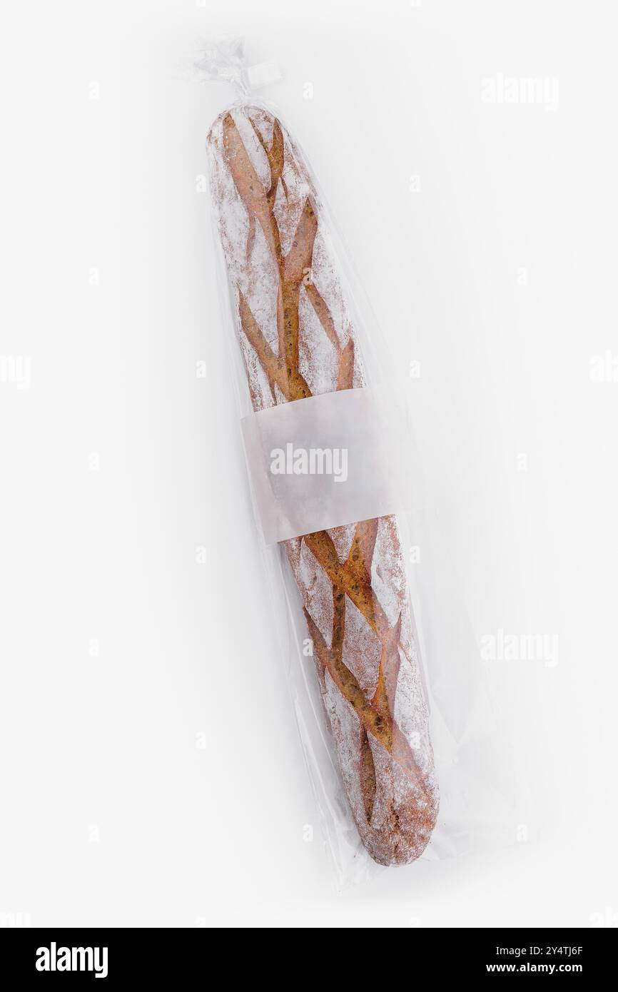 Fresh artisanal bread in plastic packaging isolated on a white ...