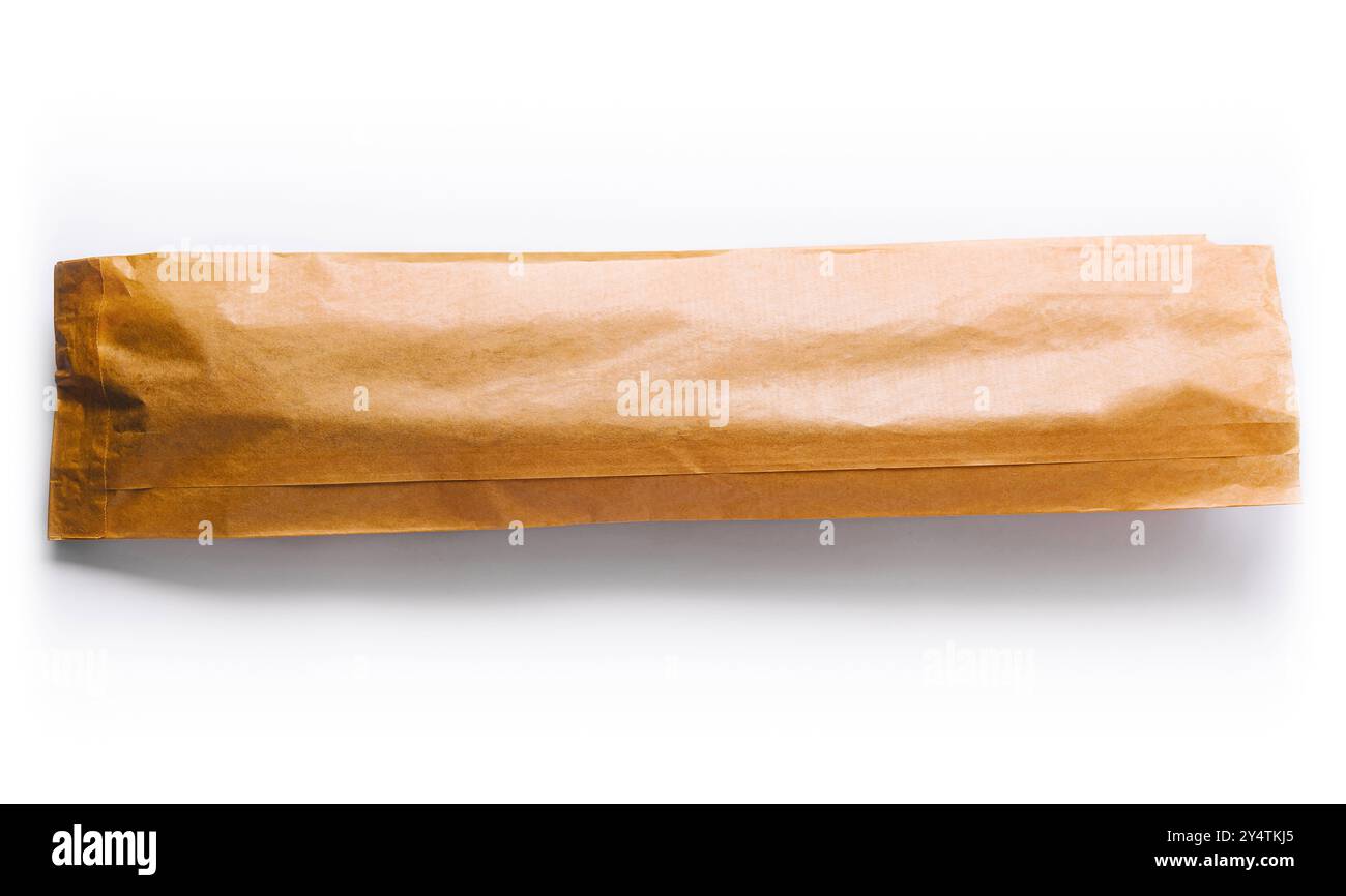 Flat lay of a crumpled brown paper bag isolated on a white background ...