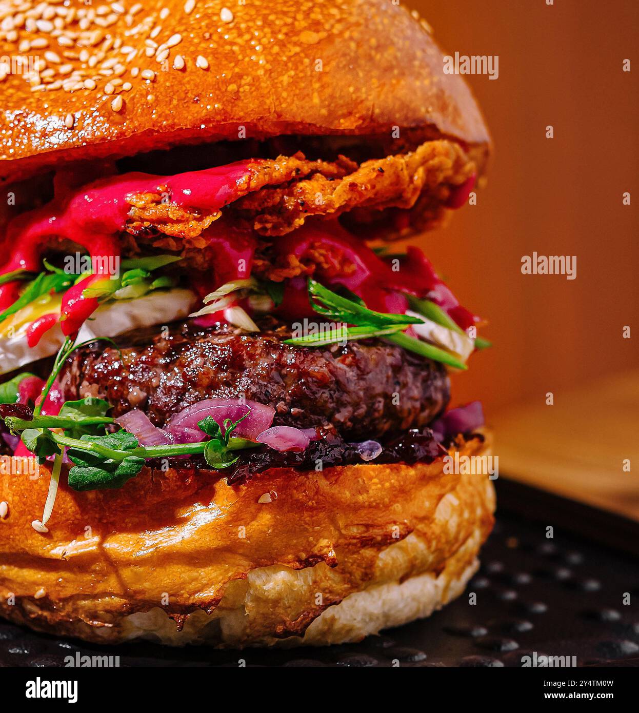 Delicious vegetable-loaded gourmet burger on a modern black tray with a ...