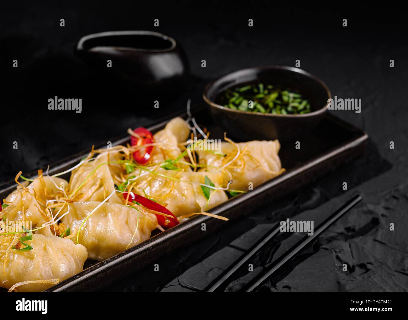 Savory presentation of steamed asian dumplings adorned with garnishes ...