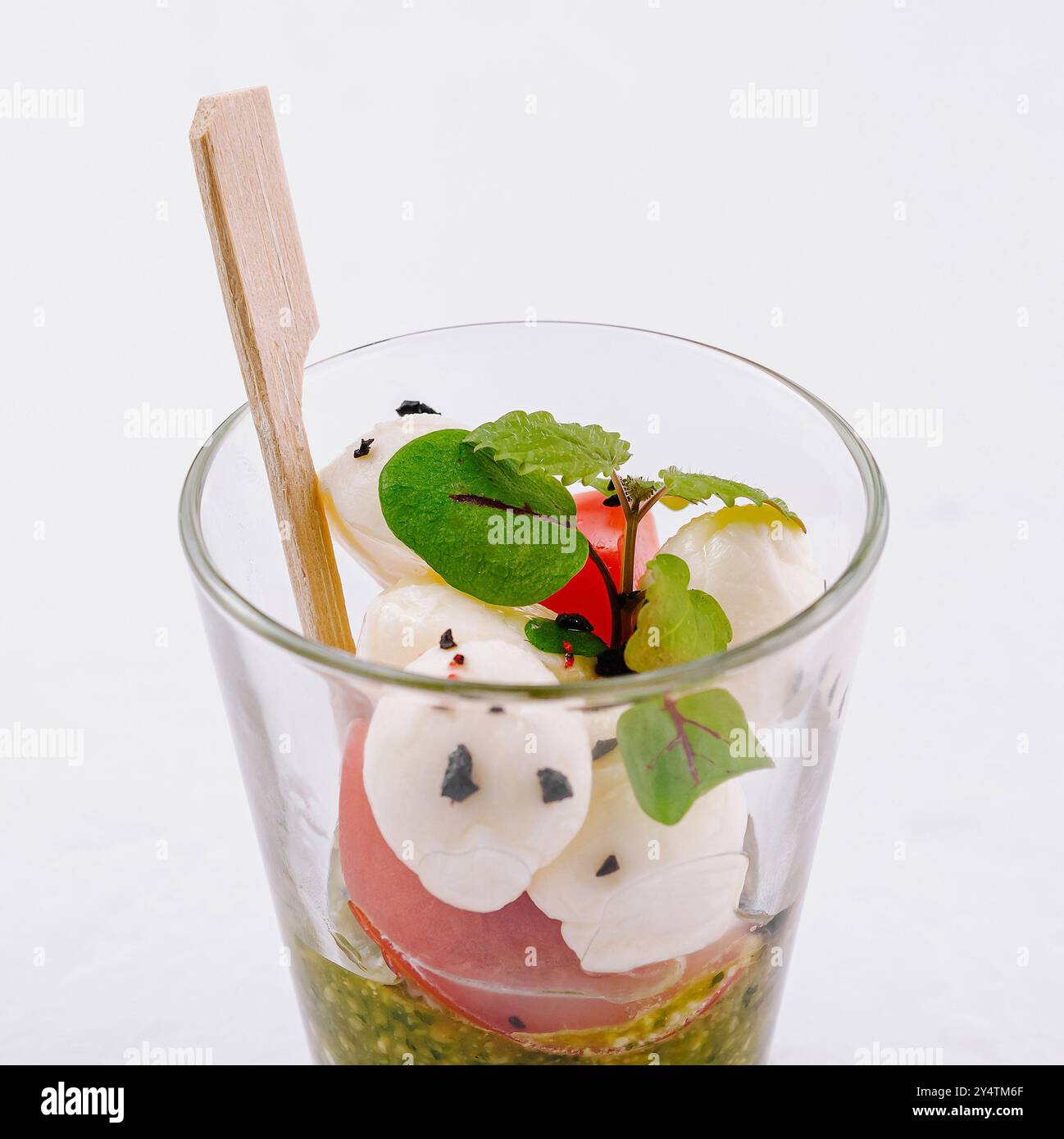 Elegant layered appetizer with sauce presented in a clear glass, styled ...