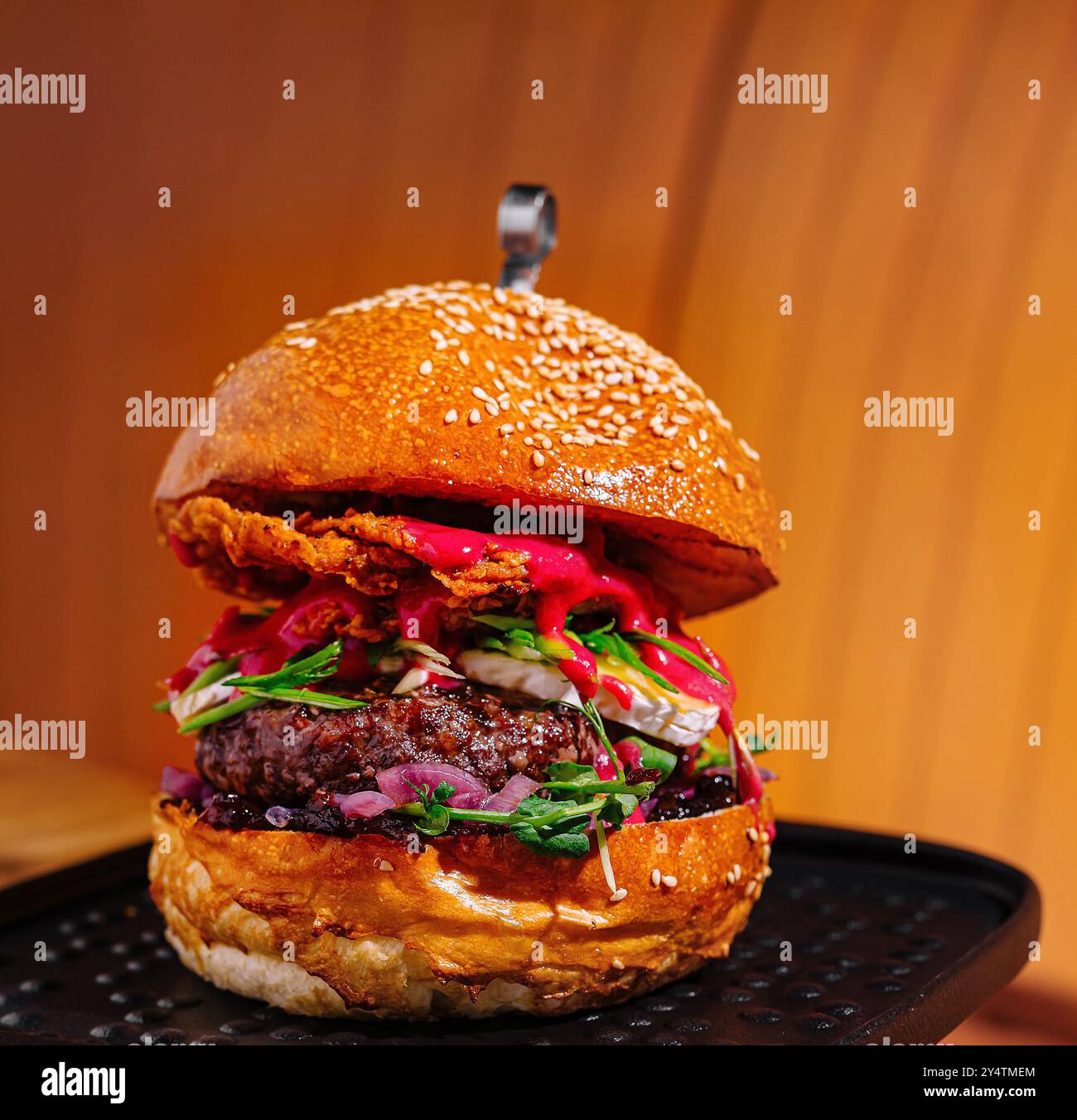 Delicious vegetable-loaded gourmet burger on a modern black tray with a ...