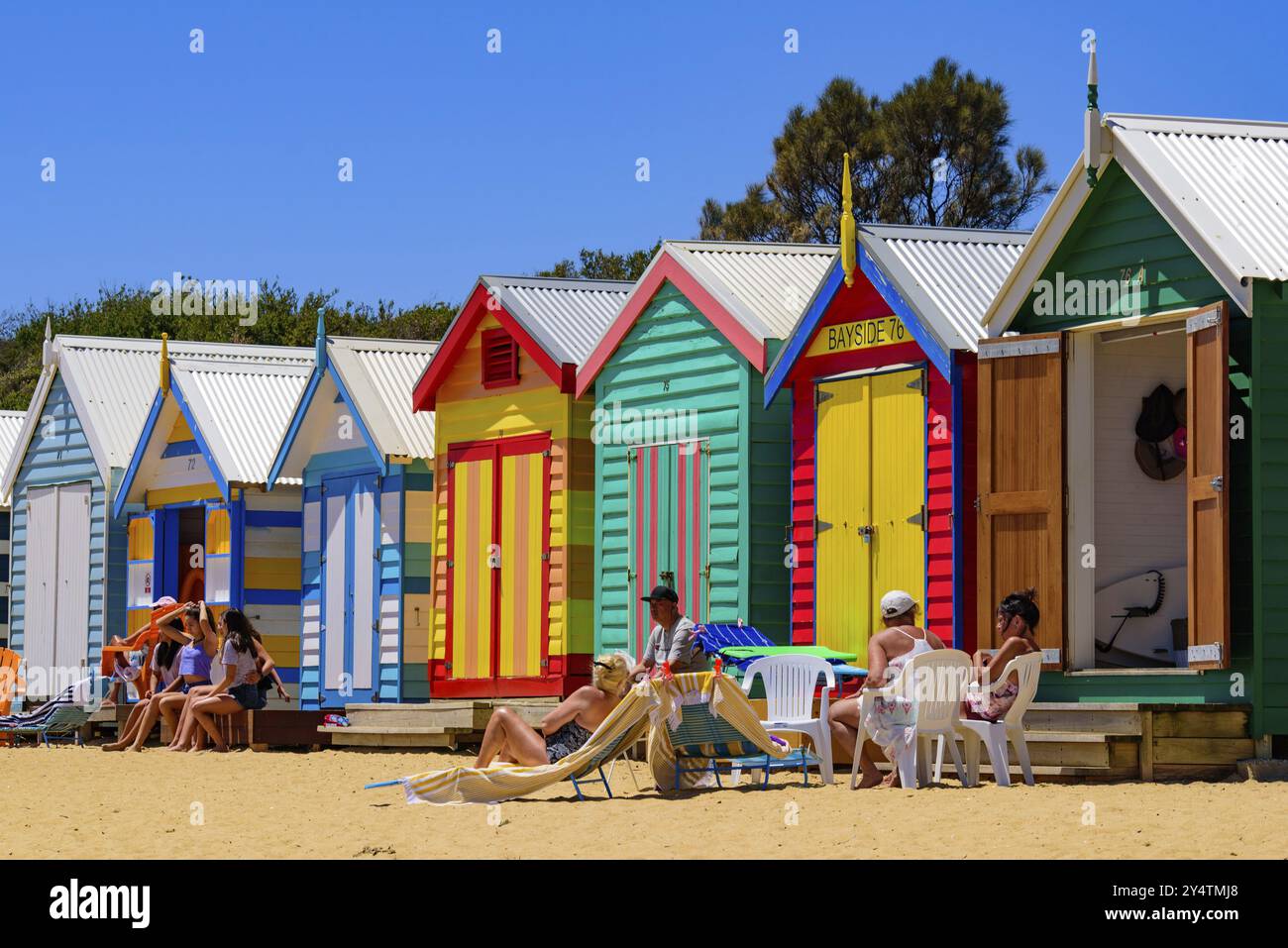 People having fun on the Brighton Beach with colorful Bathing Boxes as ...