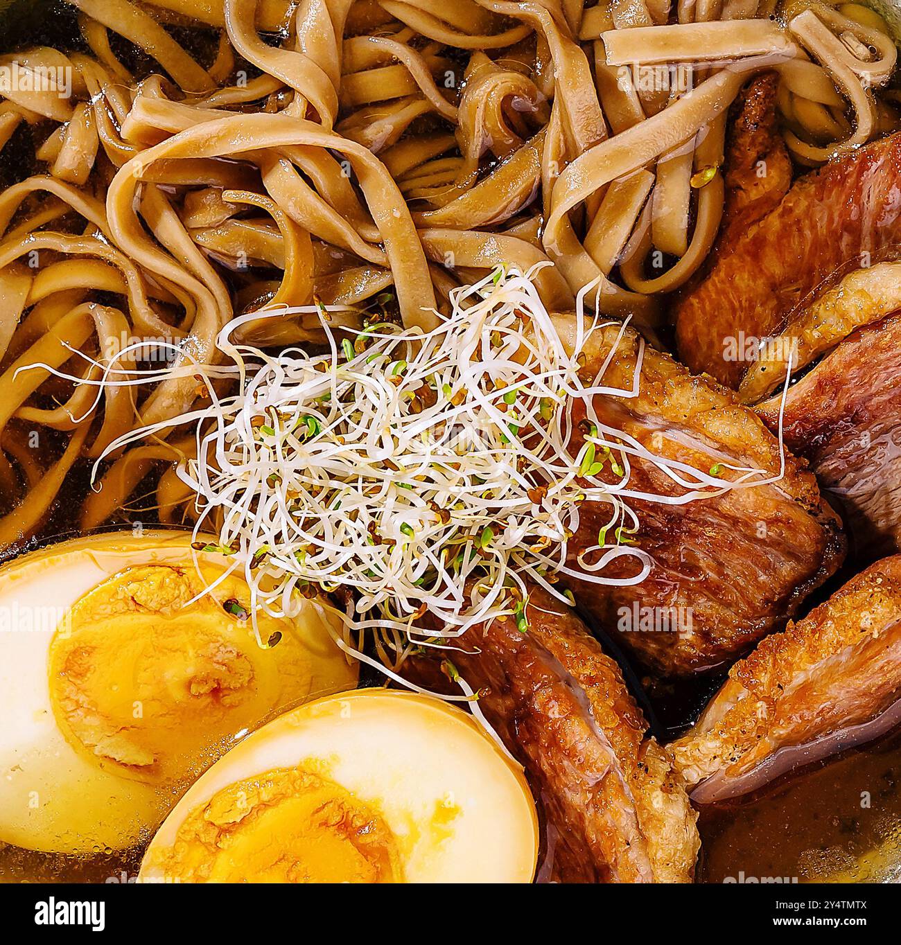 Overhead view of traditional japanese ramen with pork, egg, and sprouts ...