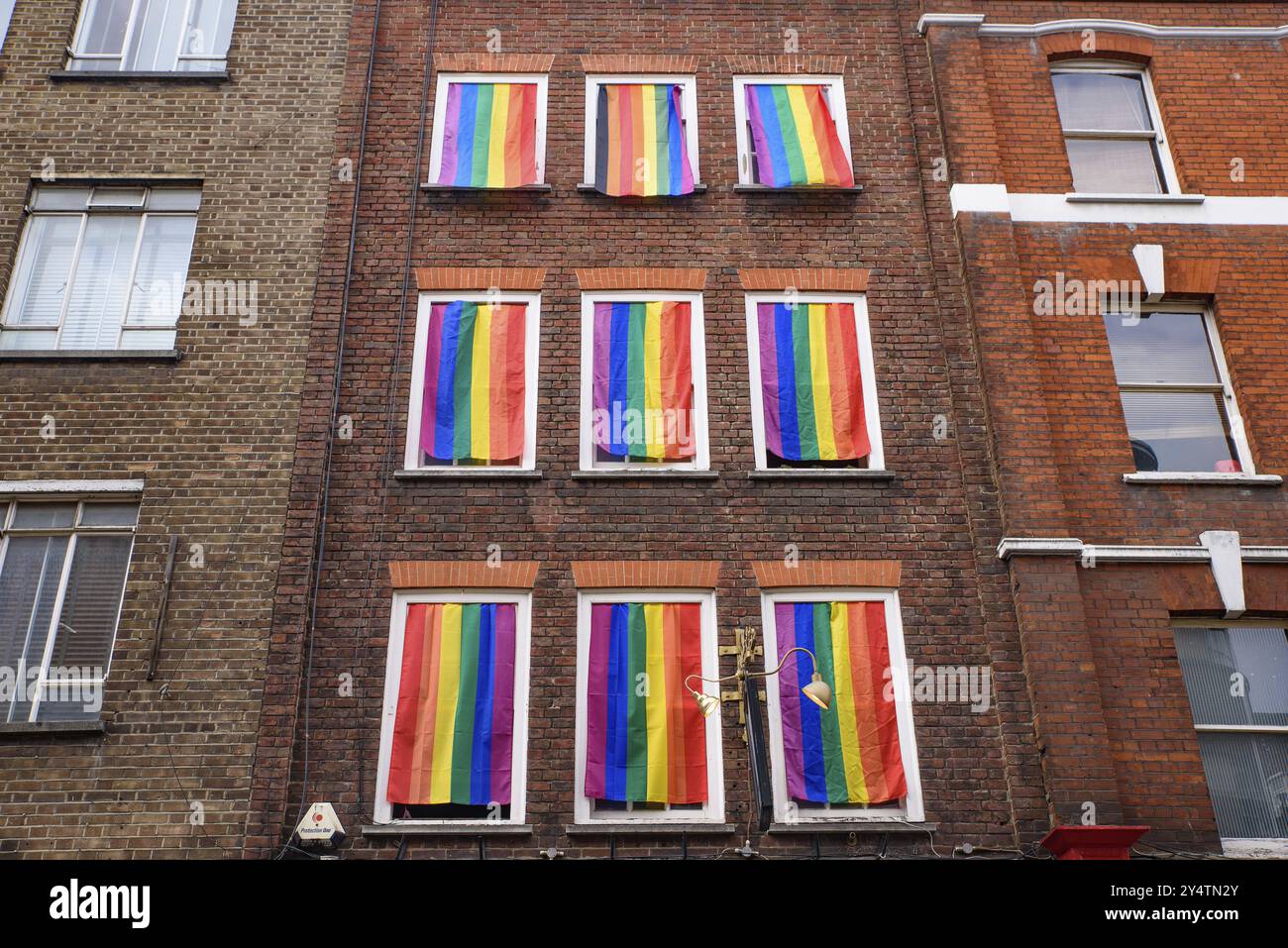 A wall with rainbow flags for LGBT community in Soho area in London ...
