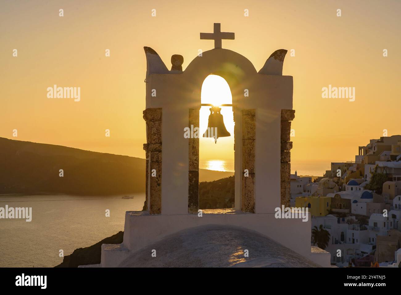 Bell tower with warm sunset light in Oia, Santorini, Greece, Europe ...