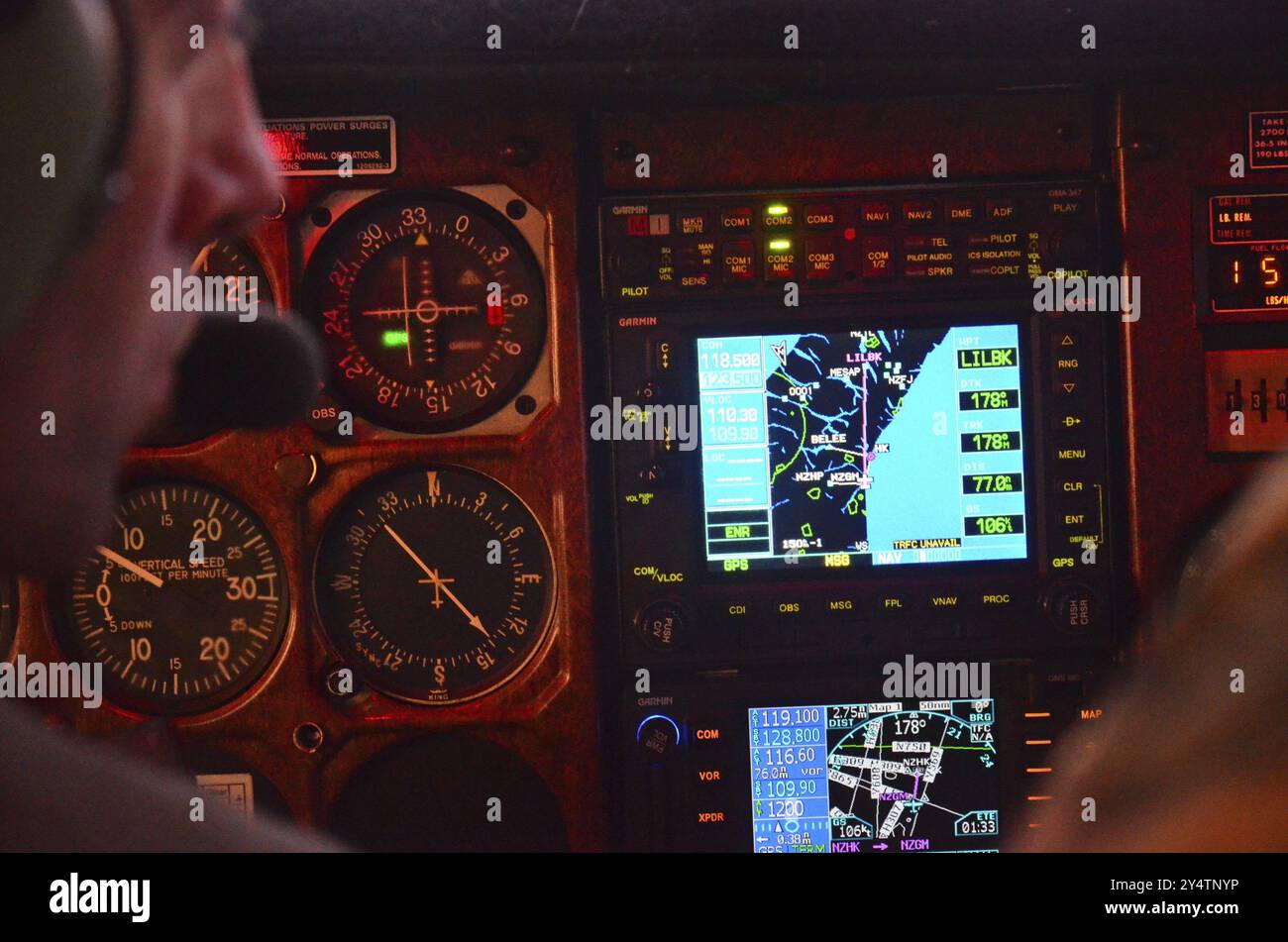 A pilot and passenger at the cockpit of a Cessna 210 light aircraft ...