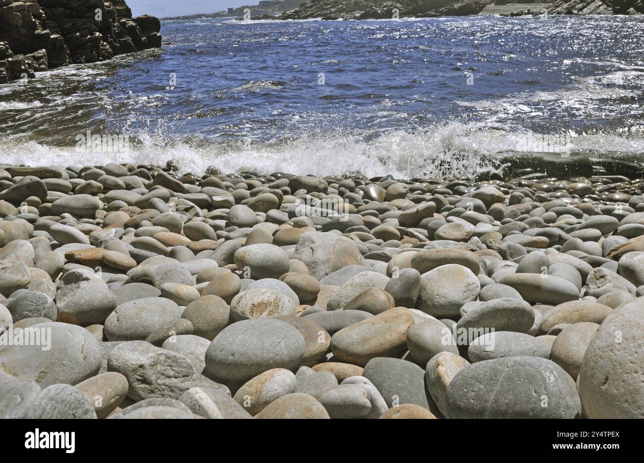 Power of nature grinded rock into round pebbles on a beach in South ...