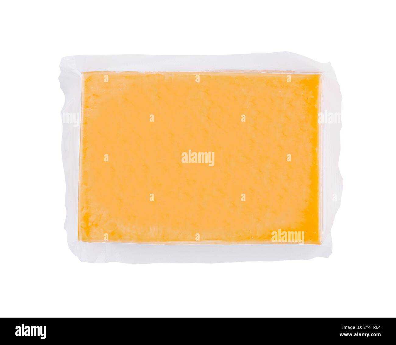 Square block of cheddar cheese is vacuum sealed in plastic wrap to ...
