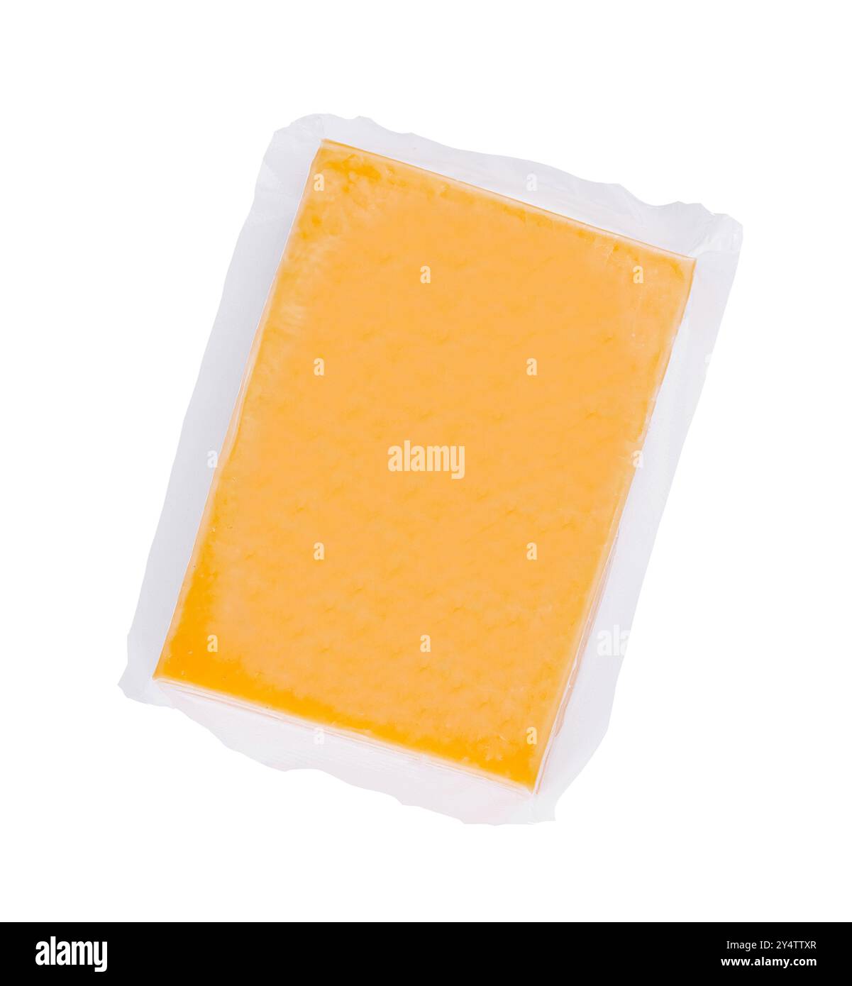 Square block of cheddar cheese is vacuum sealed in plastic wrap to ...