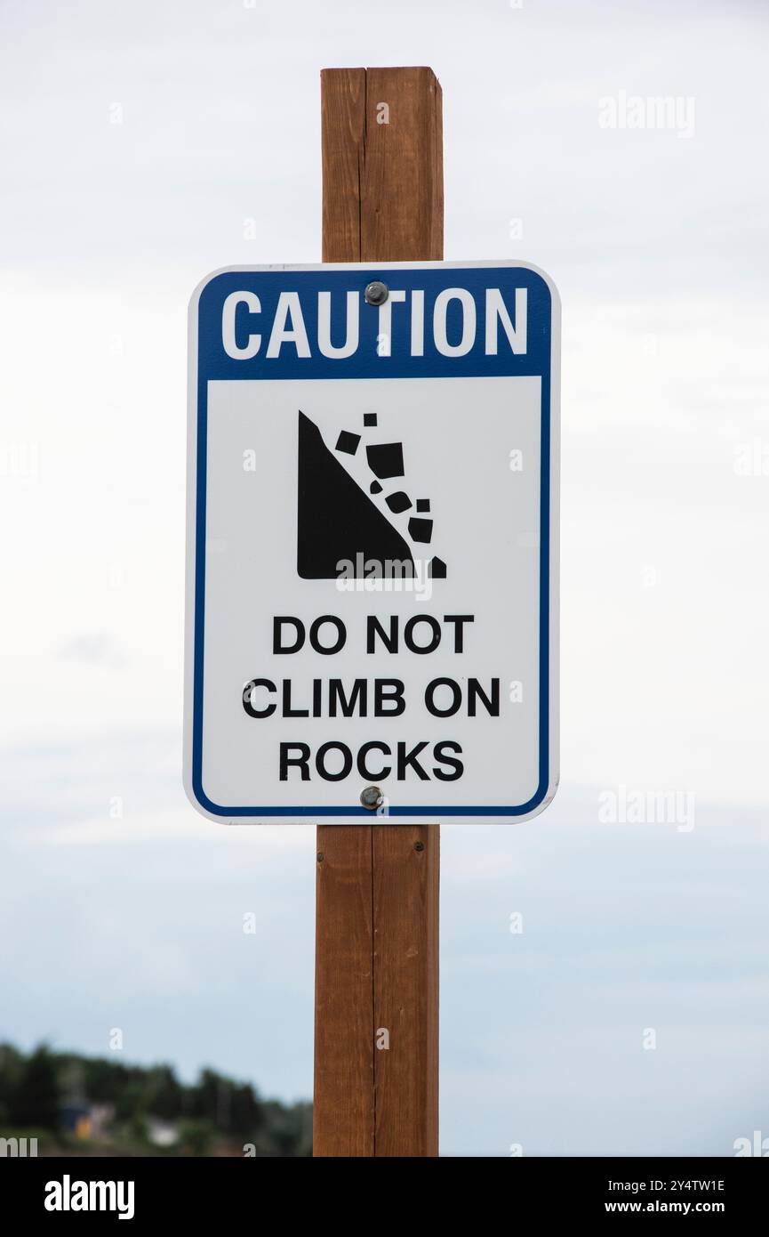 Caution sign do not climb on rocks at The Tide on Conception Bay ...