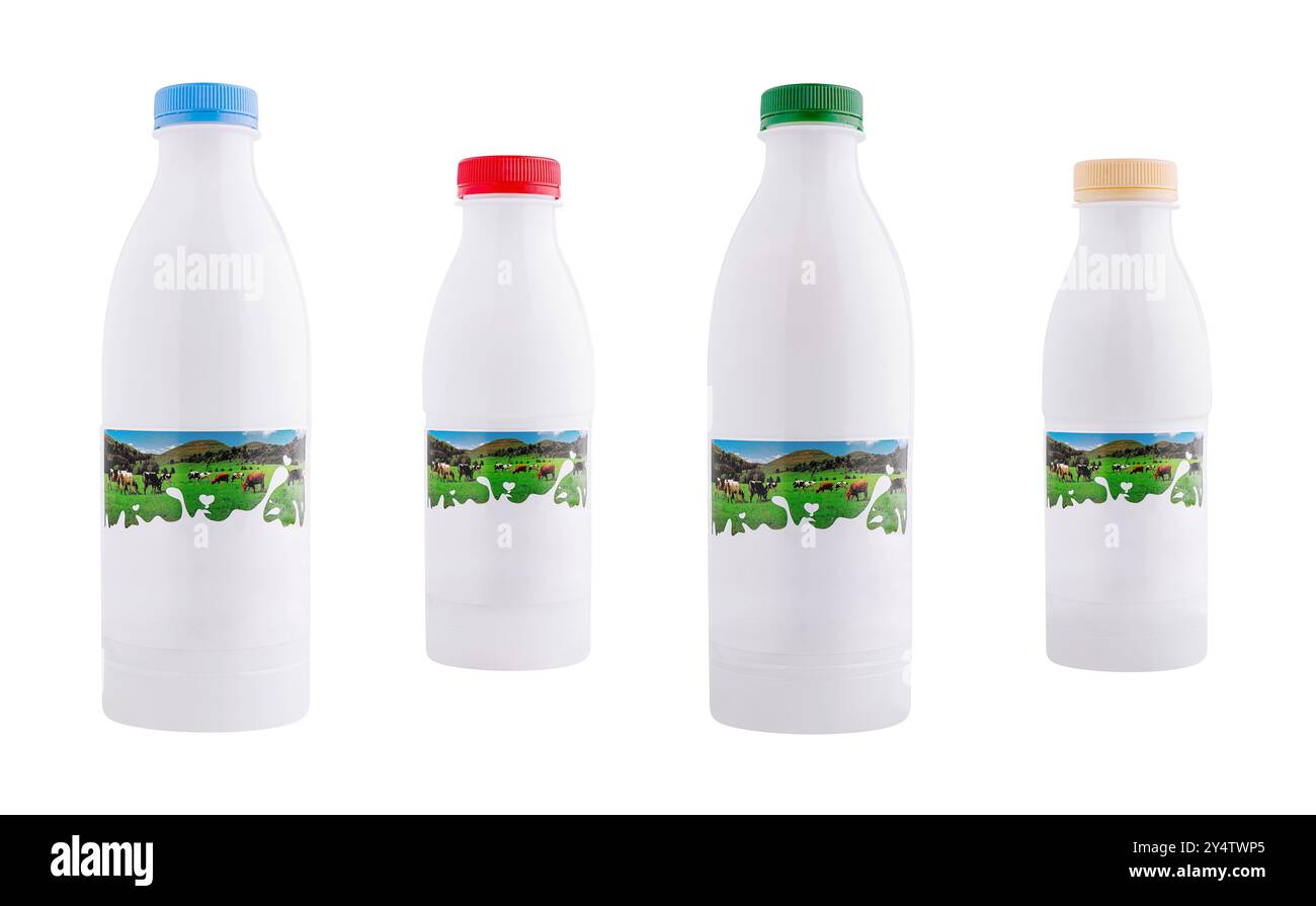 Four white plastic bottles of milk with different colored caps are ...
