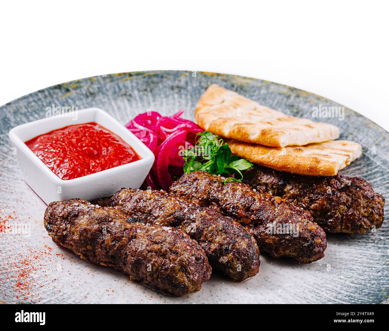 Delicious lula kebab served on plate with pita bread, adjika and onion ...