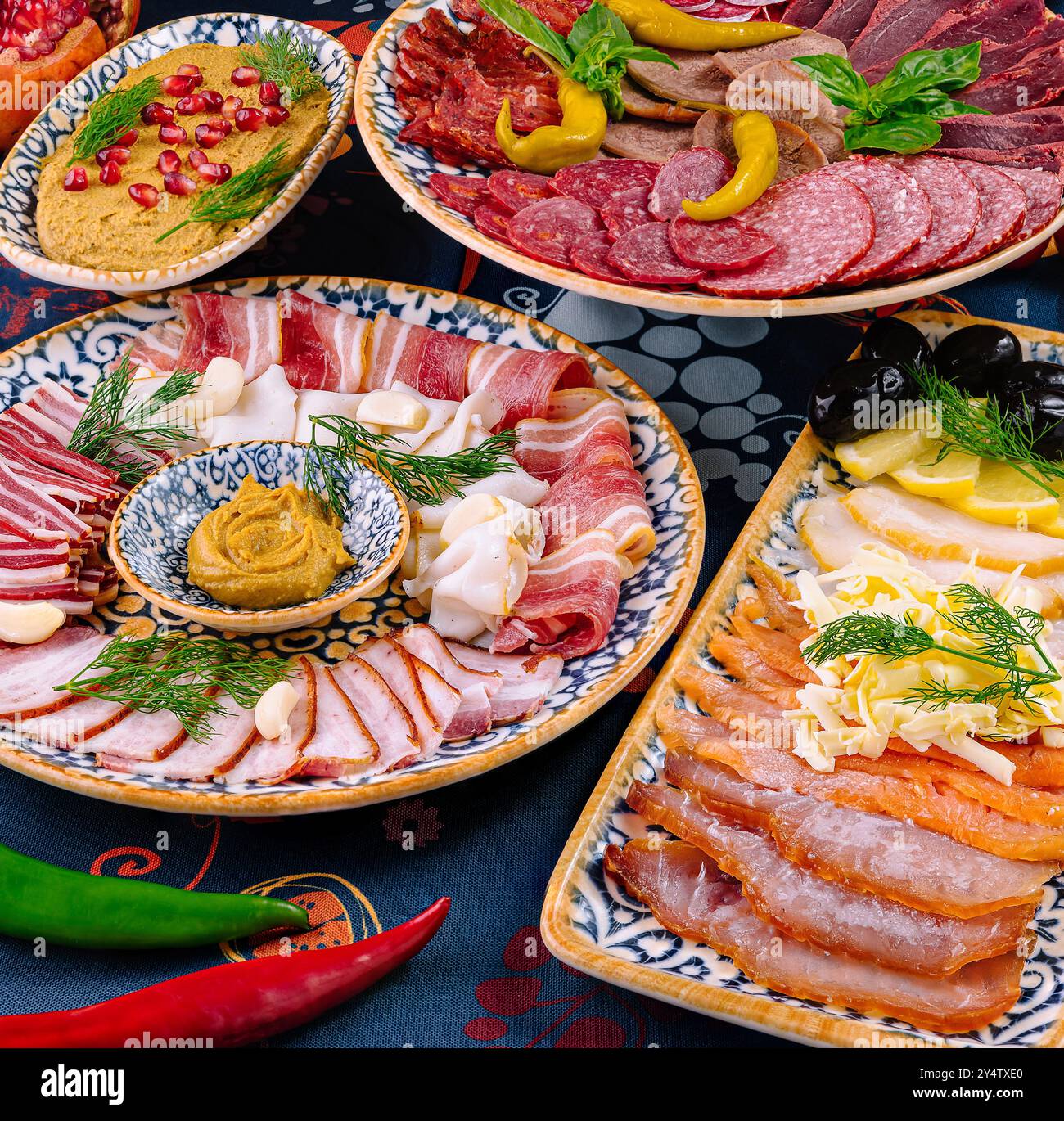 Plates with different kinds of meat and fish appetizers being placed on ...