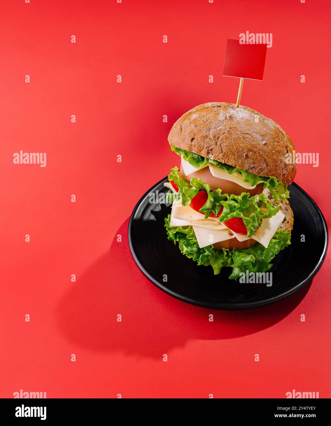 Double burger with fresh vegetables and a sausage with blank labels are ...