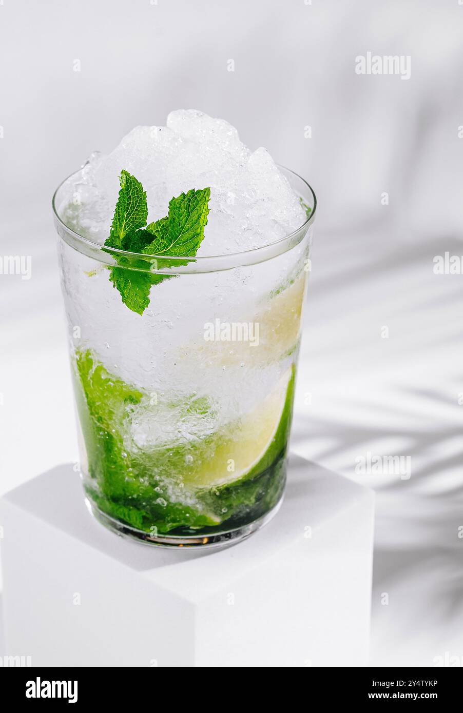 Green mojito cocktail with white rum, mint leaves, lime and ice on ...