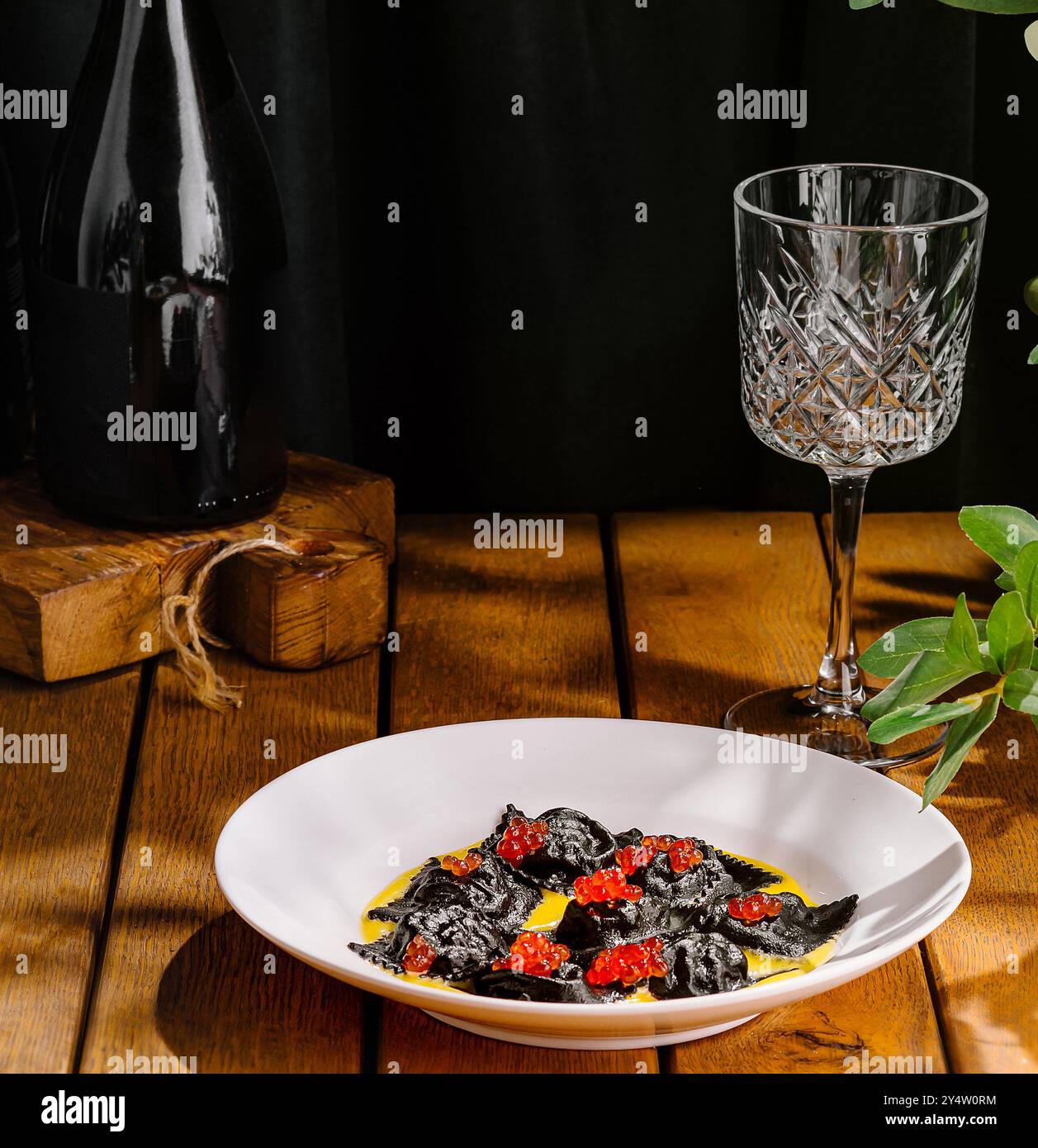 black italian ravioli on rustic wooden table, ready for a fine dining experience Stock Photo - Alamy