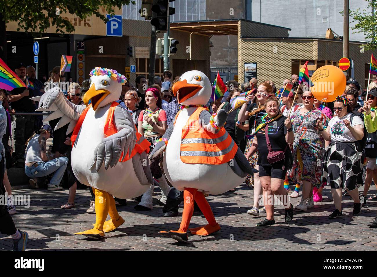 Seagull mascots with hi-vis vests marching in front of City of Helsinki ...