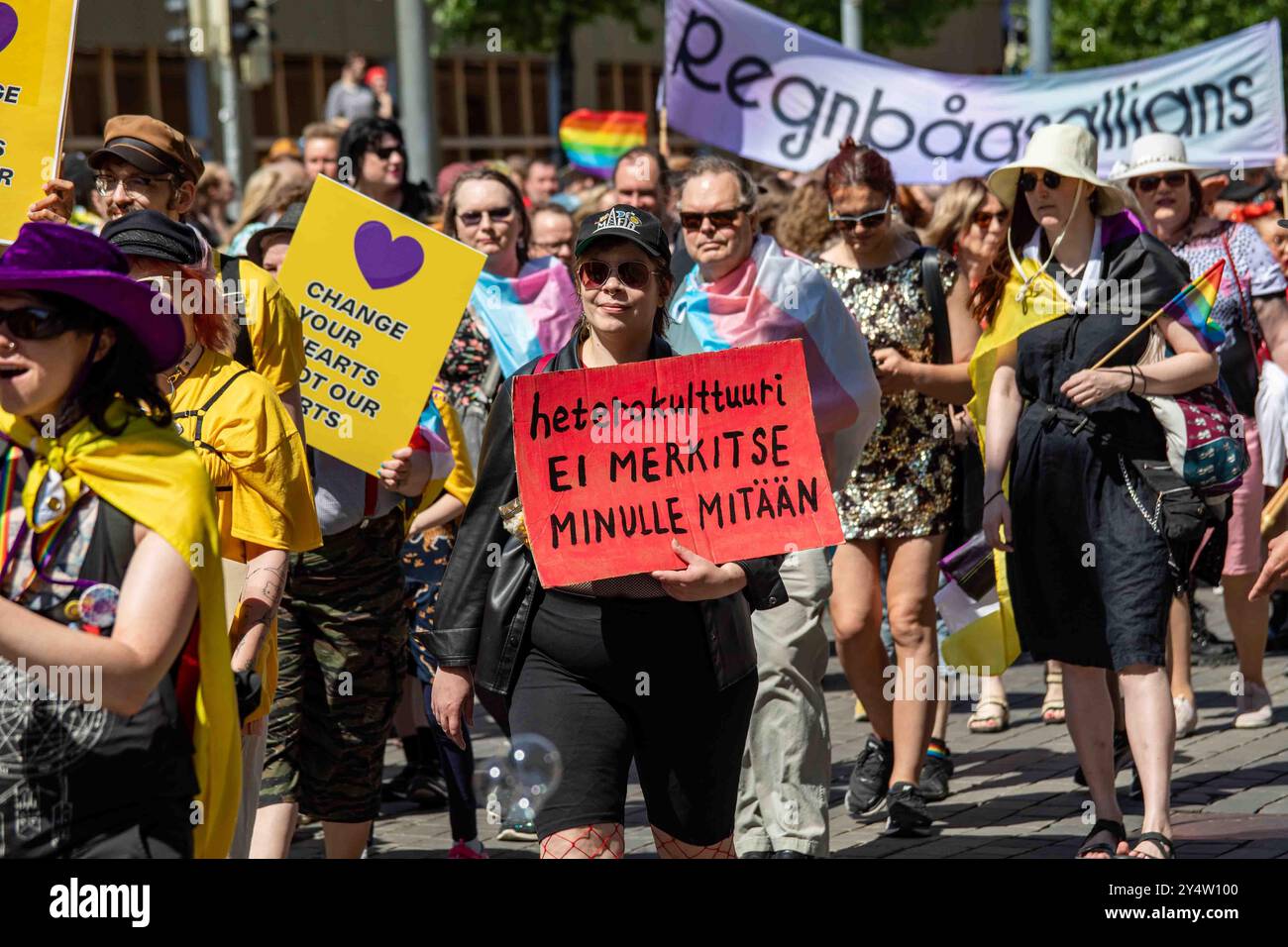 Woman with red sign at Helsinki Pride 2024 parade on Mannerheimintie in Helsinki, Finland Stock ...