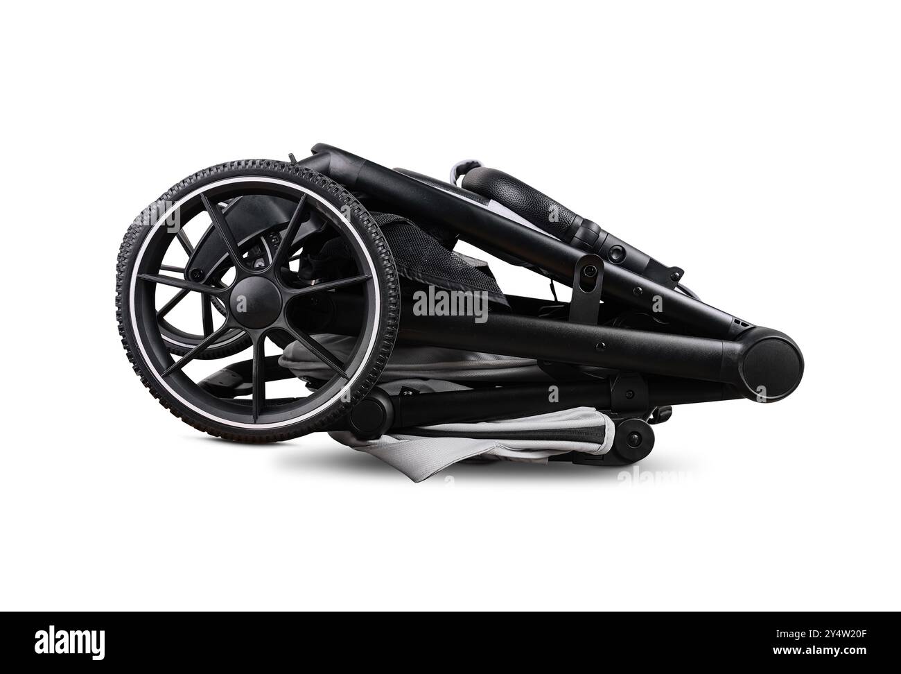 Modern baby stroller folded and lying on a white background, showing ...
