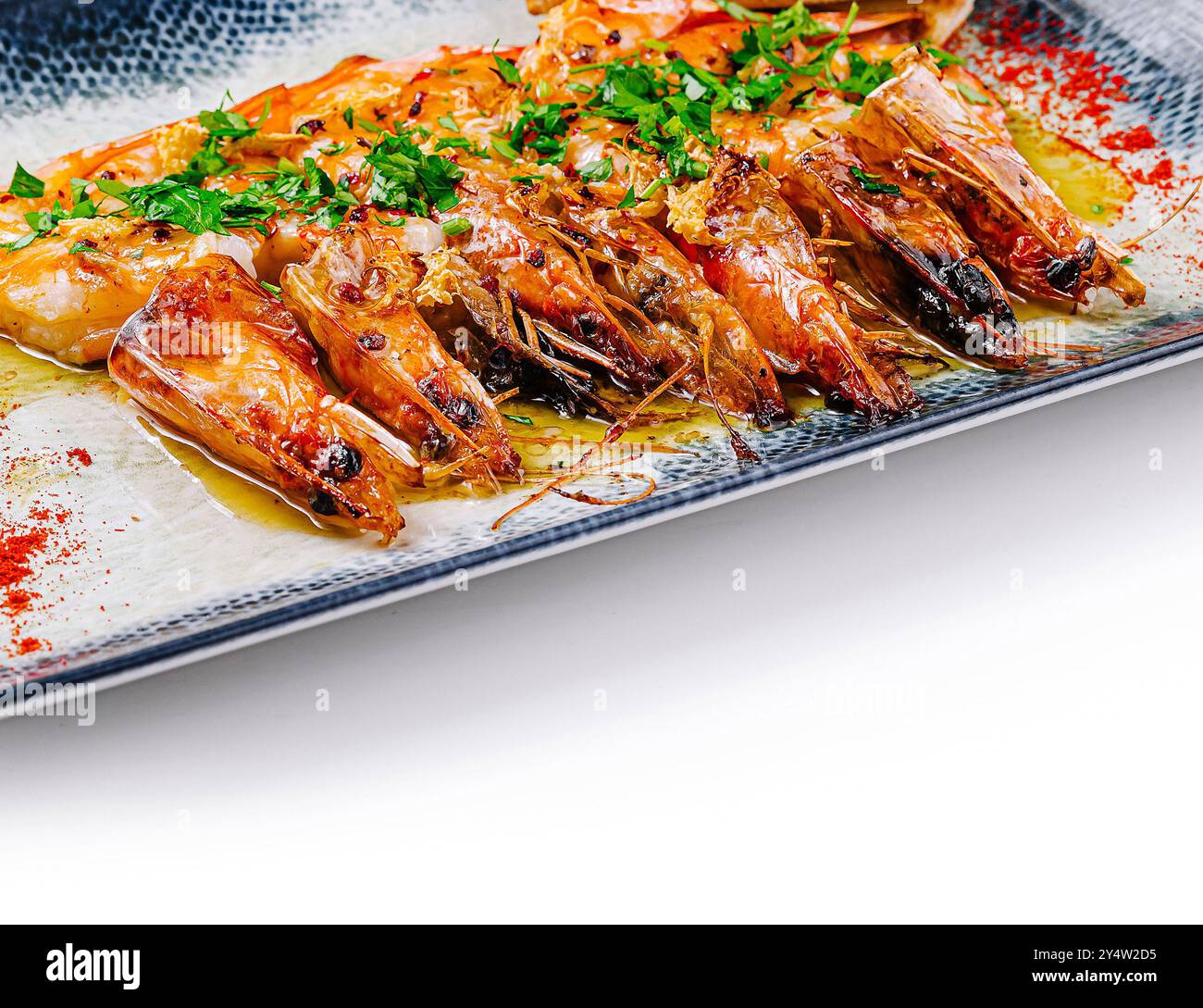 Grilled tiger prawns with spices, garlic and parsley on a rectangular plate Stock Photo - Alamy