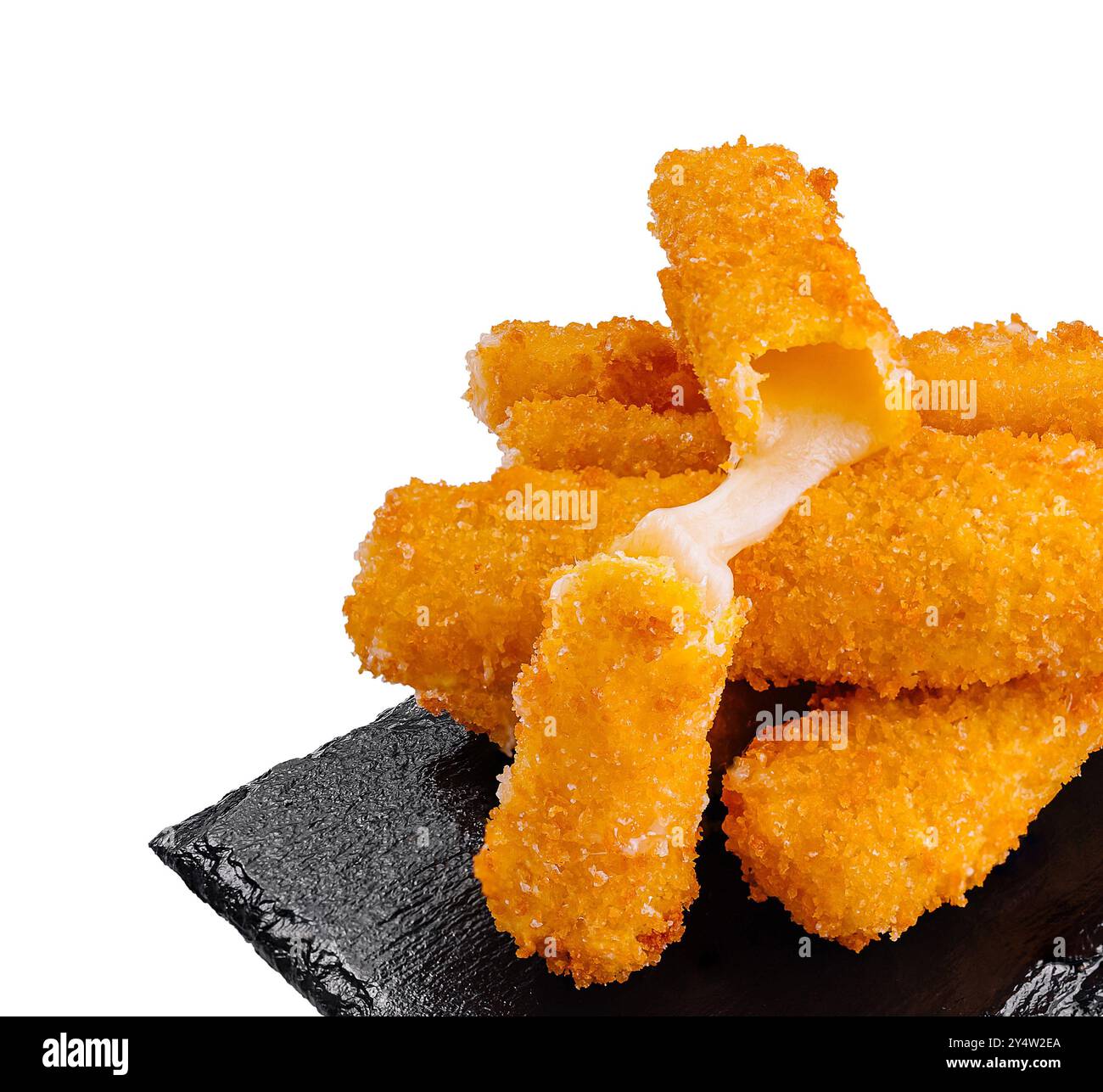 Breaded mozzarella cheese sticks are stacked on a black slate plate ...