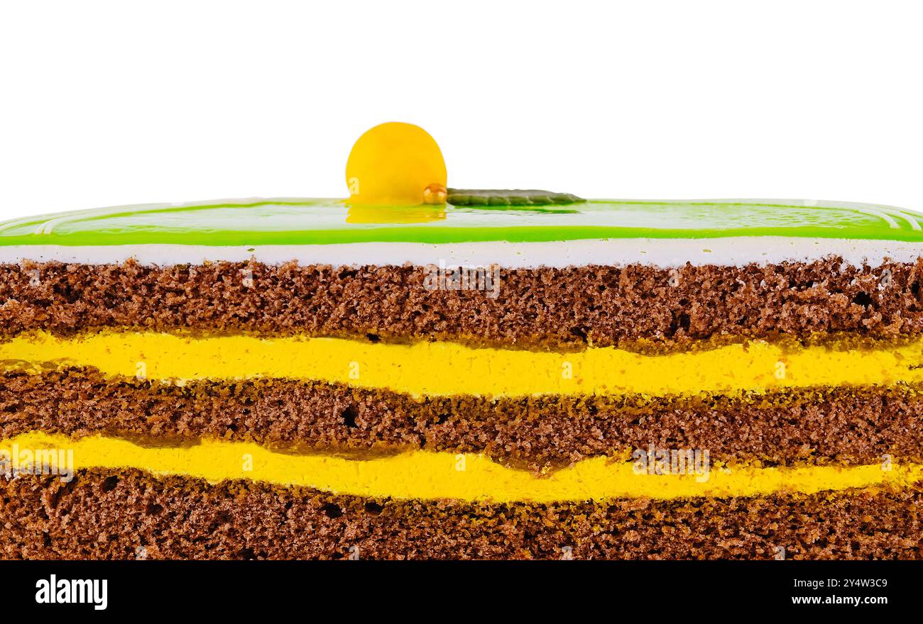 Delicious layered cake with green icing and yellow filling is showing ...