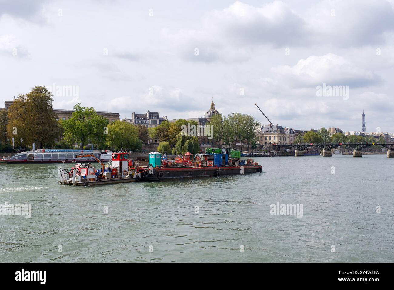 Paris, France 09.16.2024. A small cargo ship on the Seine, carrying ...