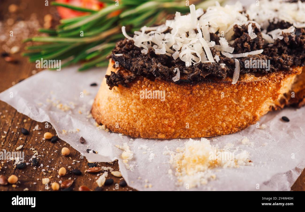 Toasted slice of bread topped with a spread made from black truffles ...