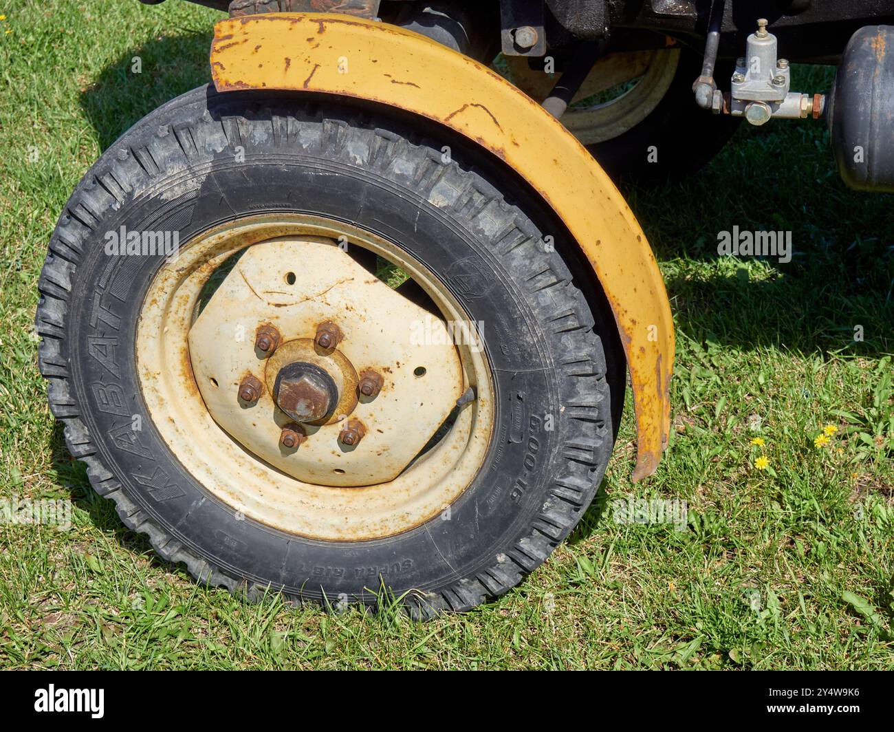 Close-up of a wheel of an old tractor on the grass Stock Photo - Alamy