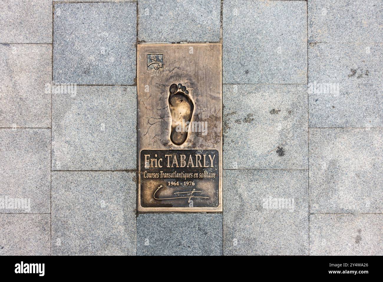 A bronze footprint of Eric Tabarly the French sailor on the footpath in ...