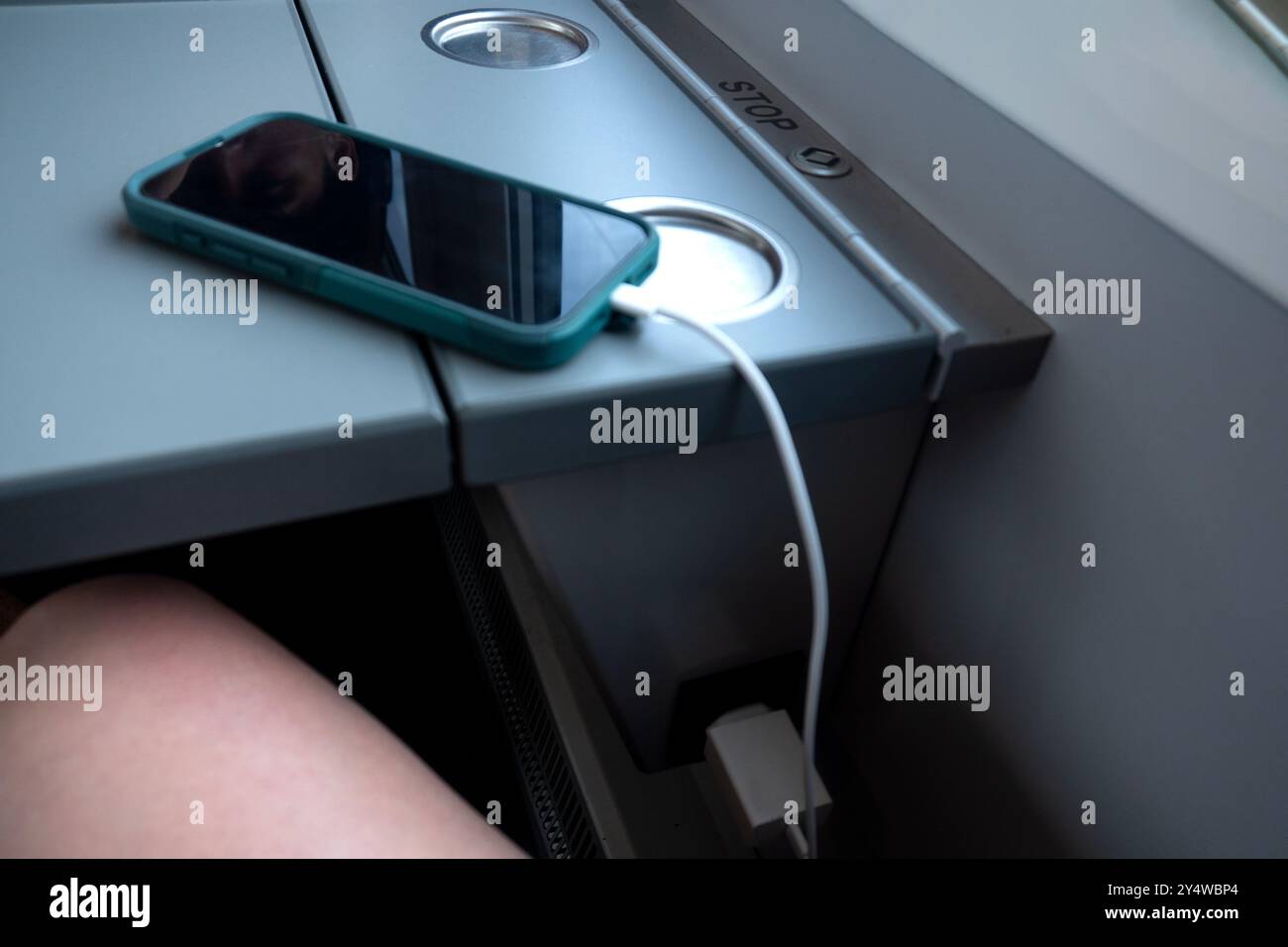charging a cell phone on the train Stock Photo - Alamy