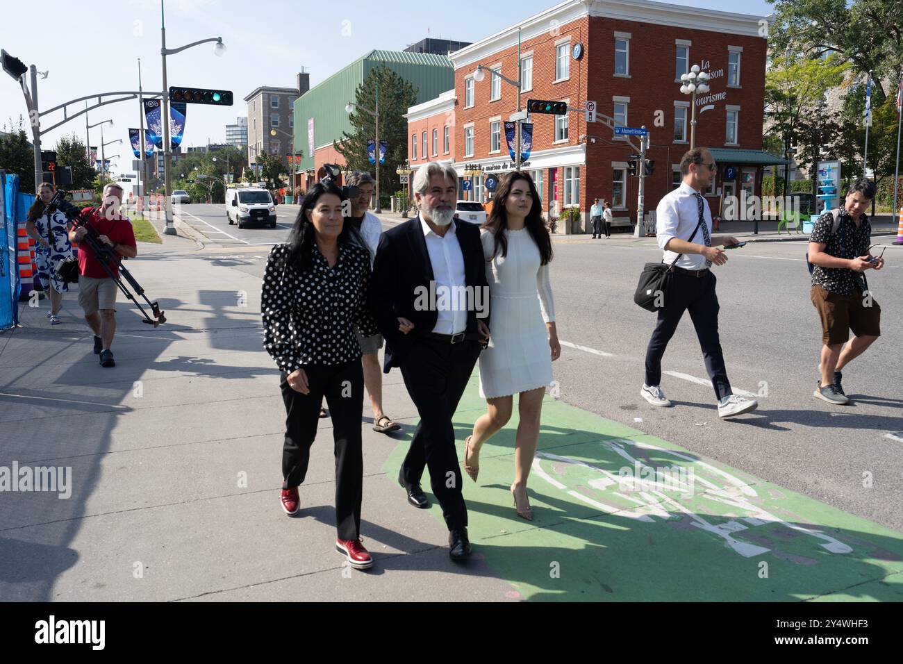 Pablo Rodriguez walks to a news conference with his wife Roxane Hardy ...