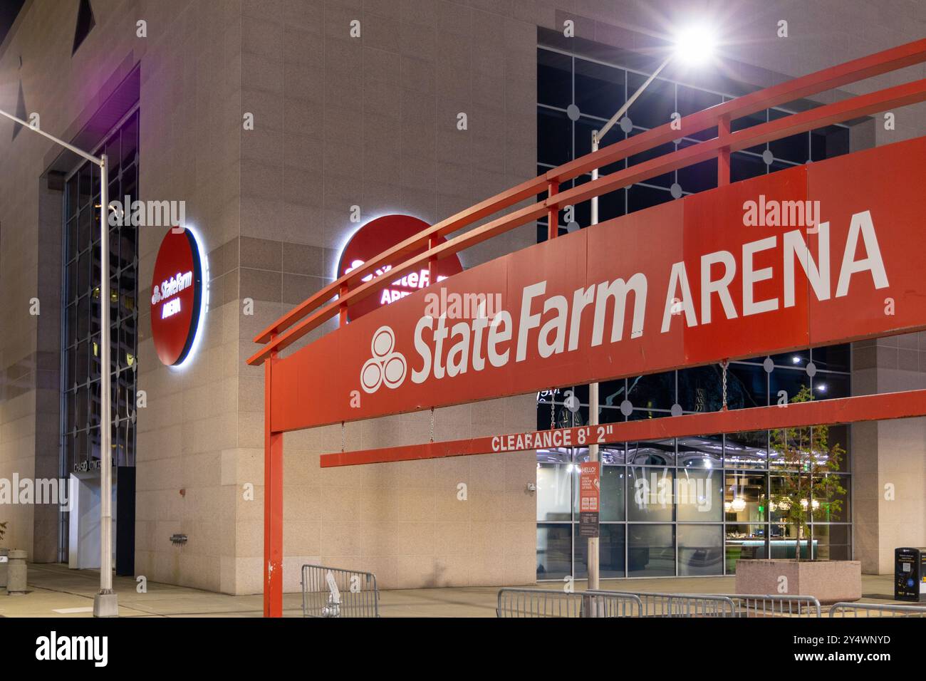 A large red sign with the word State Farm Arena on it. The sign is lit ...