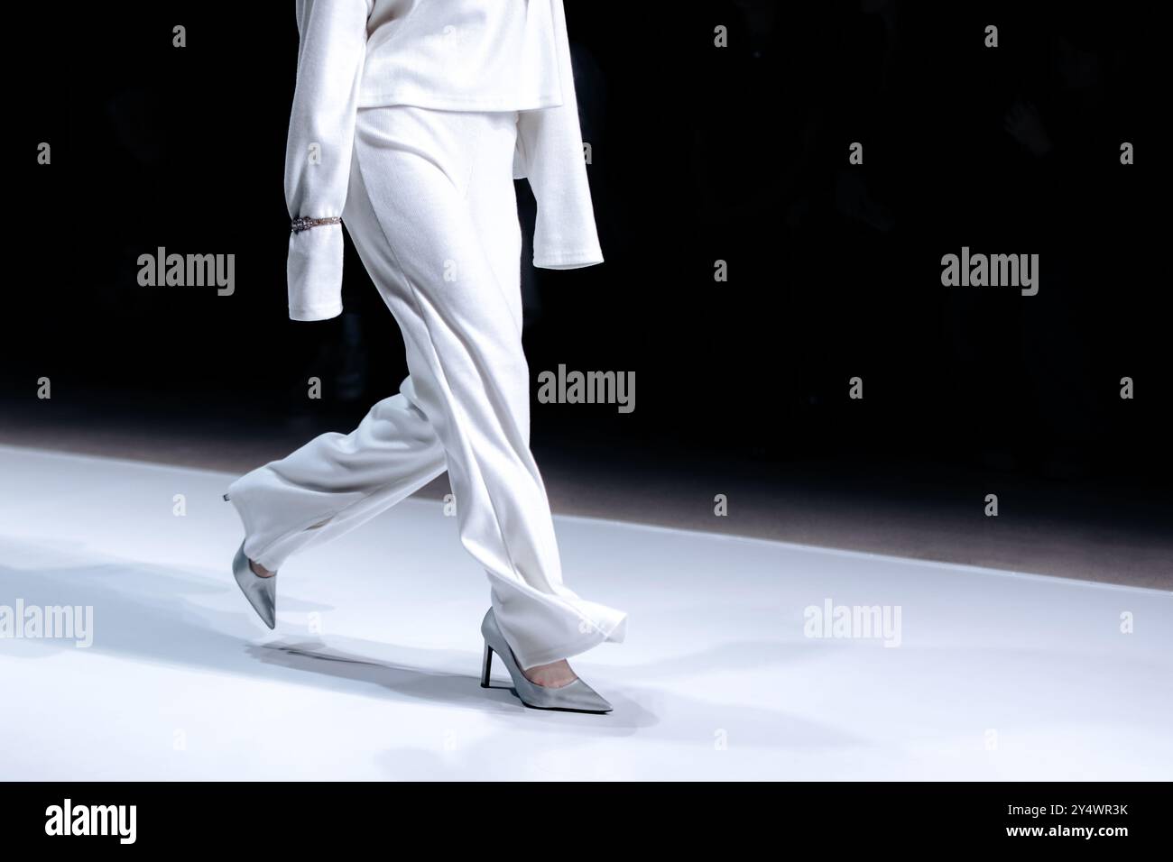 Elegant outfit, white long sweater and pants, fashion model walking on ...